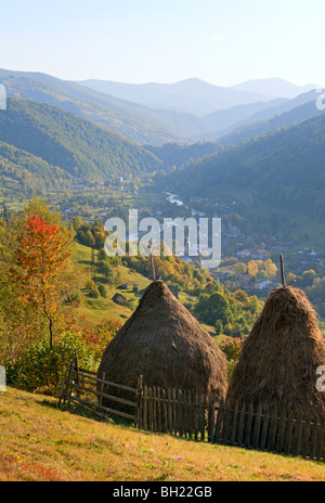 autumn mountain country view with haystacks Stock Photo - Alamy