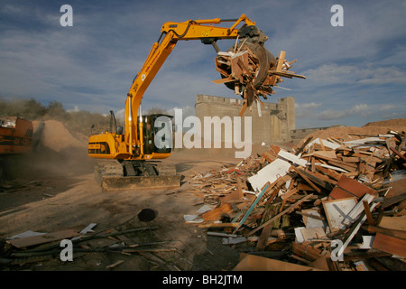A JCB digger loading recycled wood into a chipper Stock Photo - Alamy