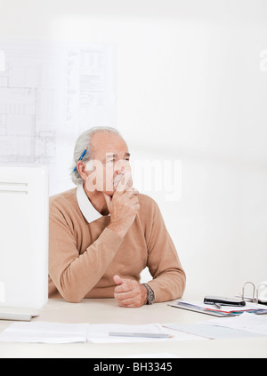 Pensive doubtful businessman brainstorming ideas working at marketing ...
