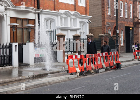 Burst water main city of London, being fixed with hole in the road ...