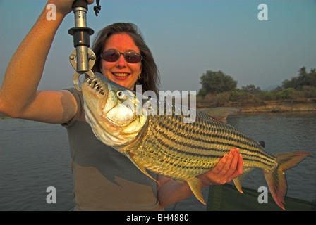 Female angler with a tigerfish Hydrocynus vittatus caught on the Lower ...