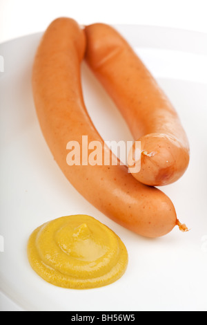 a pair of wieners on a white plate Stock Photo - Alamy