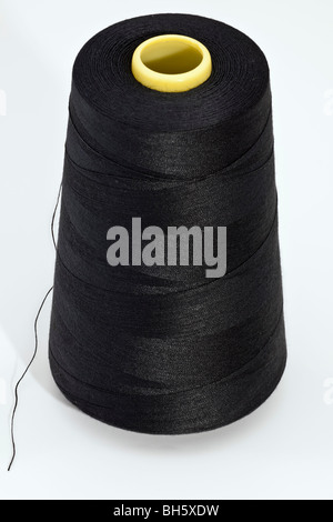 spool of black thread on white background Stock Photo - Alamy