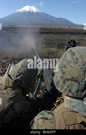 Soldiers fire .50-caliber machine gun rounds at the base of a training ...