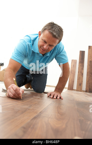 Man laying wooden flooring Stock Photo - Alamy