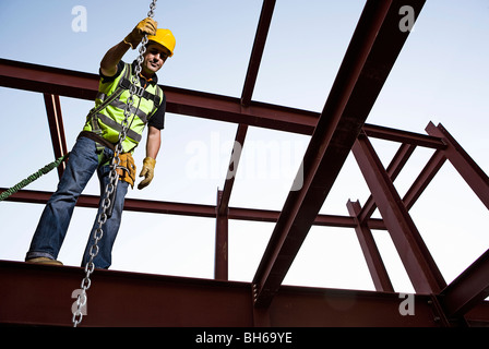Construction worker on steel beam at construction site Stock Photo - Alamy