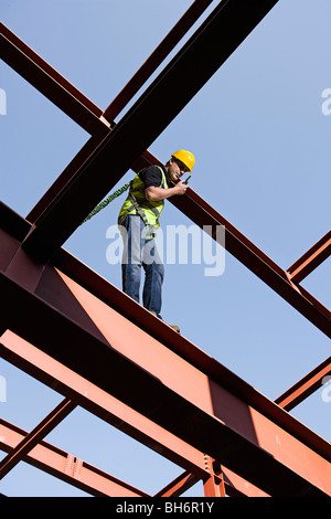 Construction worker on steel beam at construction site Stock Photo - Alamy