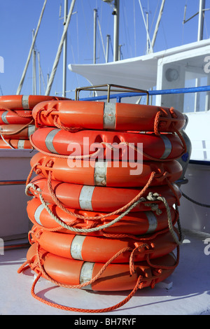 Stacked orange rescue round buoy, sea marine lifesaver Stock Photo - Alamy