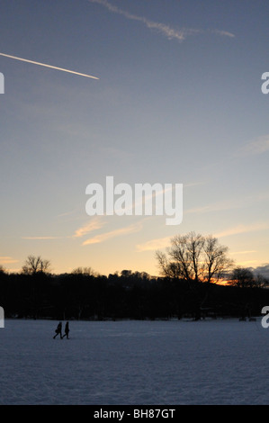 Contrails in clear winter sky Stock Photo - Alamy
