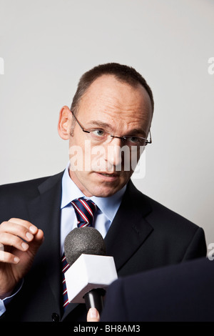 A man in a suit being interviewed Stock Photo - Alamy