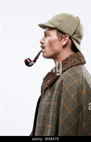A man dressed up as Sherlock Holmes standing under a building arch ...