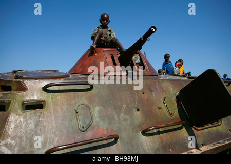 Angolan children play on an old tank on a former battle field at Cuito ...