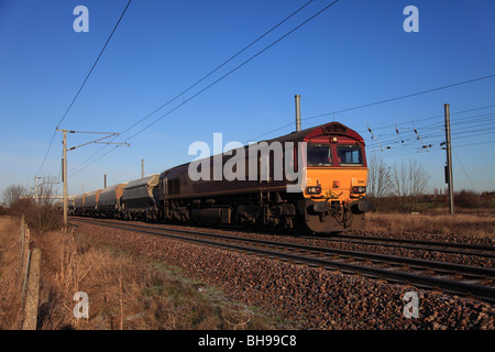 An EWS class 66 diesel pulling an empty car train, Northamptonshire, UK ...