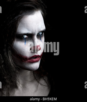 A portrait of an angry crazy clown girl in hunted house. Halloween ...