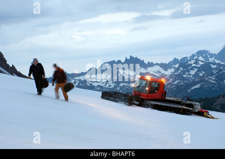 ski resort workers working around a snow grooming machine Stock Photo ...