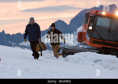 ski resort workers working around a snow grooming machine Stock Photo ...