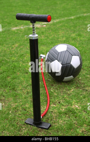 Air pump next to football awaiting inflation Stock Photo - Alamy
