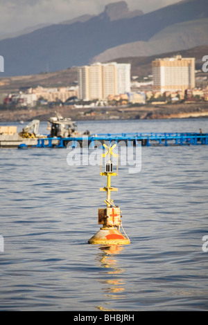 A buoy marks a fish farm off the southern side of the Spanish island of ...
