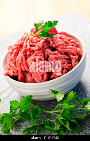Close-up of raw minced meat kebabs shaped on flat skewers, placed on ...