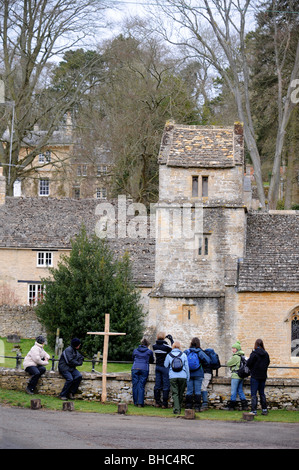 A group of country ramblers rest for lunch on the sea defence ...