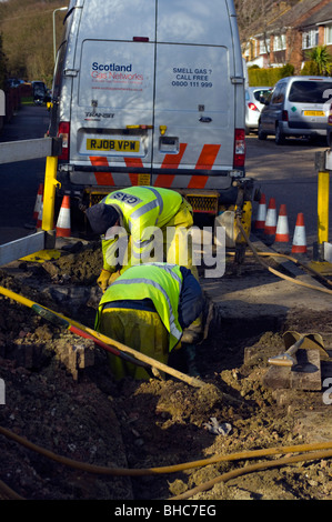 Two Workers Digging At Gas Main Repair Works In A Residential Street ...