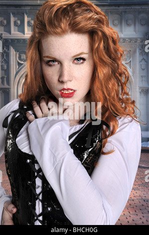 Young vampire looking straight with hand over shoulder Stock Photo - Alamy