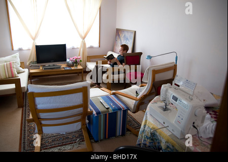 An untidy living room lounge in a student house the morning after a ...