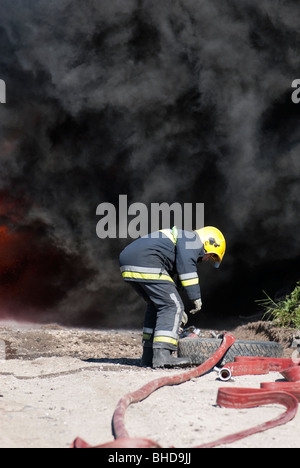 Fireman with ground monitor Stock Photo - Alamy