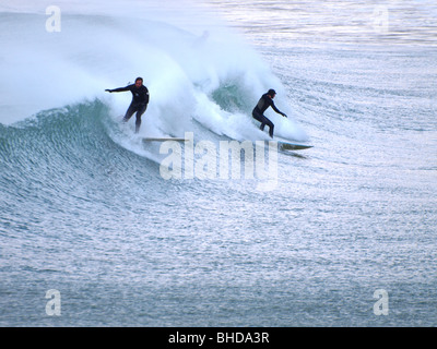 Two surfers riding same wave about to collide in California Stock Photo ...