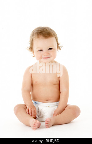 A twelve year old boy sitting on the rocks as the tide comes in at ...