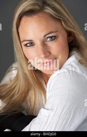 Portrait of a woman wearing a white shirt and elegant shawl outdoors ...