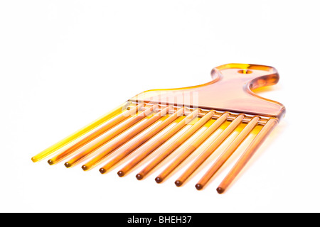Wide plastic afro comb from low viewpoint isolated against white ...