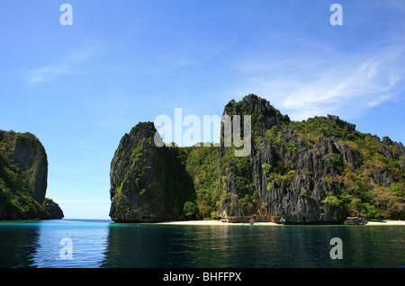 Sandy beach on an uninhabited limestone island in the Bacuit ...