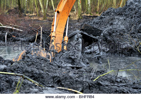 Mechanical digger stuck in mud Stock Photo - Alamy