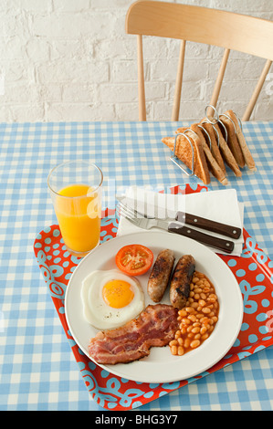 Man eating traditional English breakfast with vegetarian sausage London ...