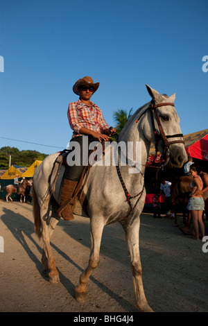 Costa Rican cowboy riding his horse on the beach in Jaco, Costa Rica ...