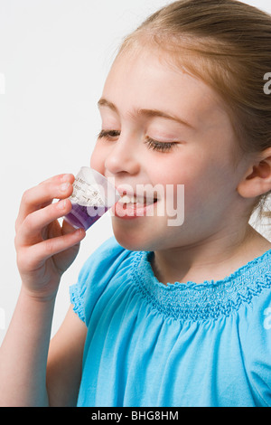 Girl taking medicine Stock Photo - Alamy