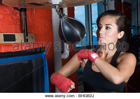 Young female boxer punching speed bag in gym Stock Photo: 133935463 - Alamy