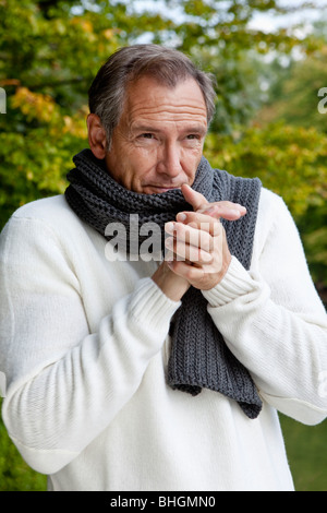 Man freezing in front of heating radiator Stock Photo - Alamy