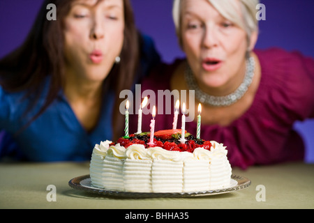 Two women with a birthday cake Stock Photo - Alamy