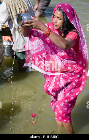 Woman performing a Hindu purification ritual, on the headwaters of the ...
