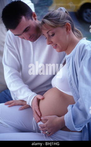 Partner feeling baby kick Stock Photo - Alamy