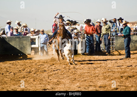 A cowgirl competes in the breakaway roping event during the O'Odham ...