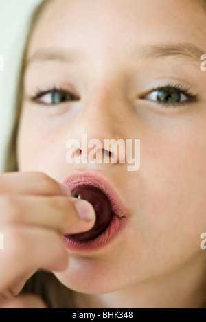 cropped view of kid hold cherry bowl on yellow background. copy space ...