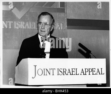 A portrait of the 41st President George H. W. Bush is draped in black ...