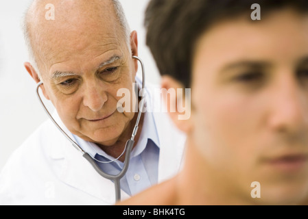 Doctor conducting medical exam Stock Photo - Alamy