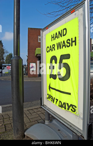 hand car wash sign with left pointing arrow on an office building Stock ...