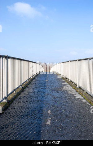 A footbridge over the M3 motorway in Surrey is shown in this black and ...