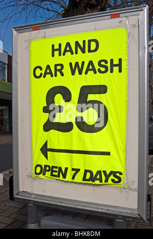 hand car wash sign with left pointing arrow on an office building Stock ...