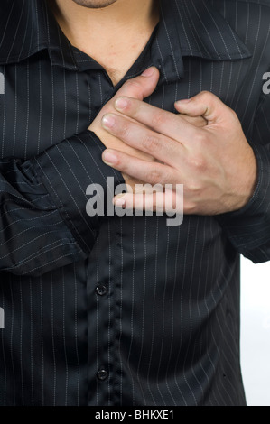 Man hands grabbing chest having a heart attack Stock Photo - Alamy